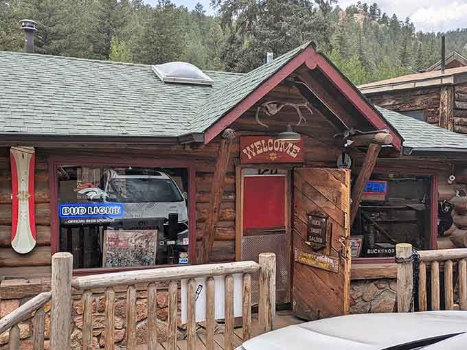 That rustic log cabin exterior isn't just for show; it's your first hint that something authentically Colorado awaits inside.
