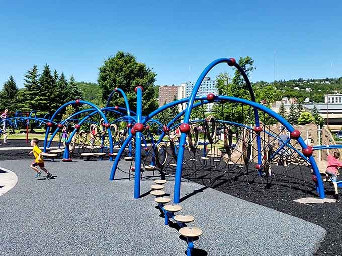 This playground's blue climbing structure looks like something from a kid's wildest dreams, minus the candy coating.