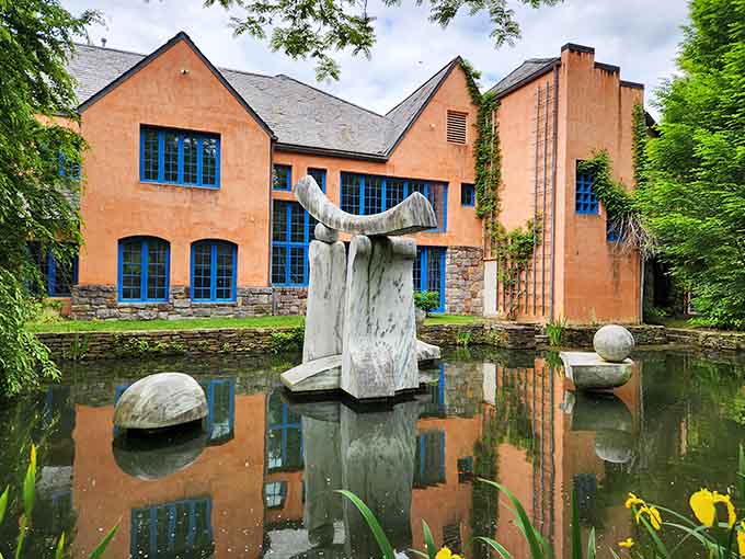 Art meets architecture in this stunning reflection, where sculptures dance across water like they're auditioning for Swan Lake.