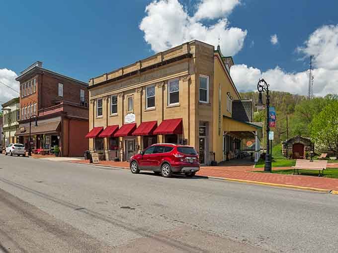 Those cheerful red awnings pop against spring-green mountains like a postcard that forgot postcards aren't supposed to be this authentic.