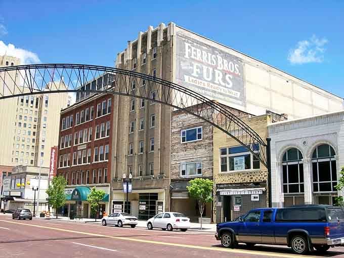 Ghost signs whisper stories of industrial glory days while modern life hums along these surprisingly walkable streets.