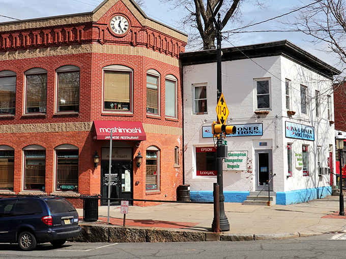 Main Street's historic buildings stand shoulder to shoulder like old friends, their colorful awnings and street-level shops proving that charm doesn't require a corporate makeover.