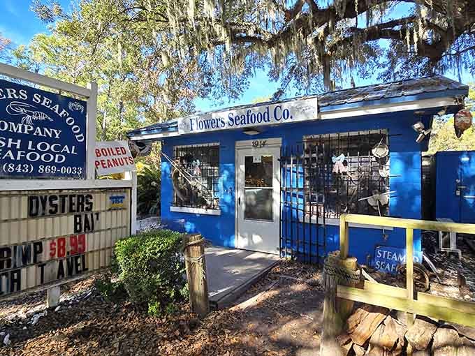 That cheerful blue building under the moss-draped oaks is your gateway to the freshest seafood on Edisto Island.