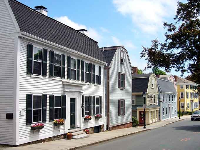 Colonial homes lined up like a paint chip display, proving New England has always understood the assignment.