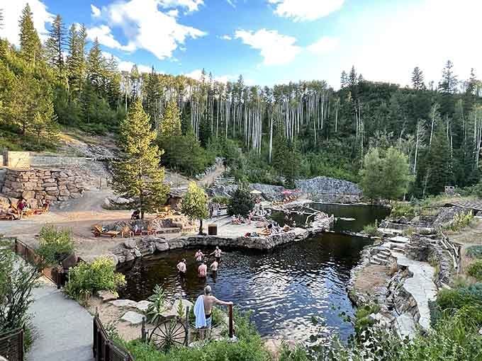 Natural stone pools cascading through pine forest create an Instagram moment that actually lives up to the hype.