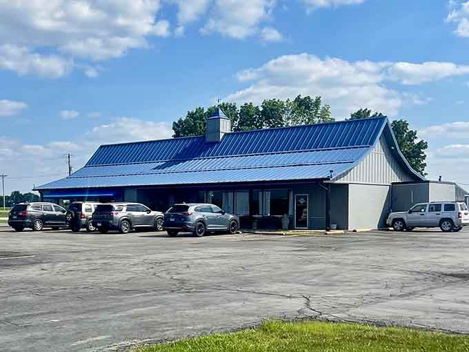 A full parking lot under dramatic clouds tells you everything: this unassuming cafe serves something worth the drive.