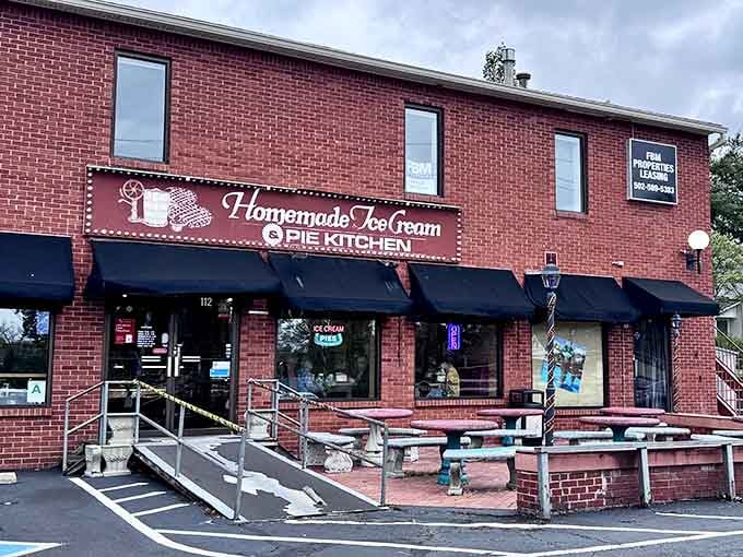 That charming brick facade and twinkling lights promise sweet treasures waiting inside The Pie Kitchen.