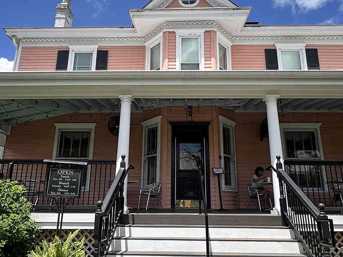 That coral-pink Victorian exterior isn't just pretty; it's your first clue that something special awaits inside.