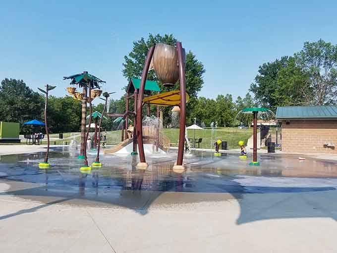 The splash pad's giant bucket dumps water like nature's surprise party, and everyone's invited to get soaked.