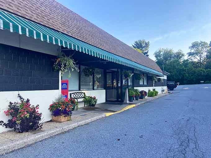 Hanging baskets frame the entrance like nature's welcome committee, inviting you into a world of comfort food perfection.