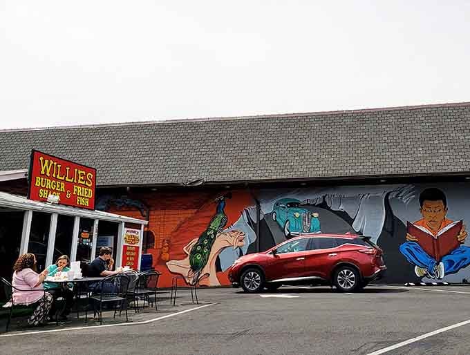 That colorful mural and humble setup prove the best burgers don't need fancy buildings, just serious skills.