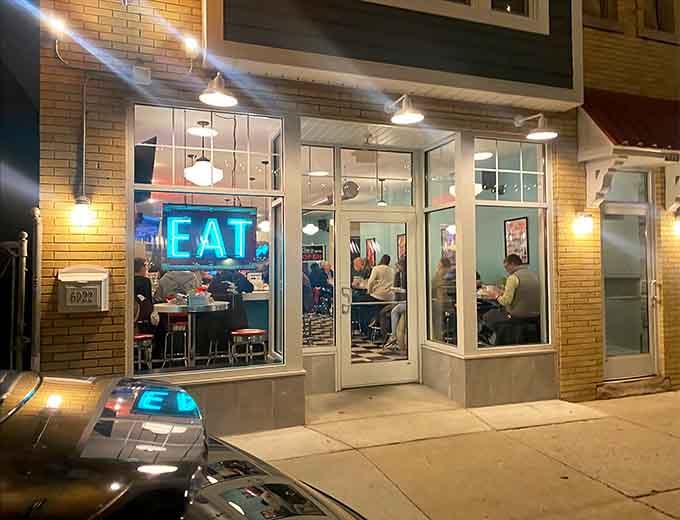 That glowing blue "EAT" sign isn't making a suggestion, it's issuing the world's friendliest command.