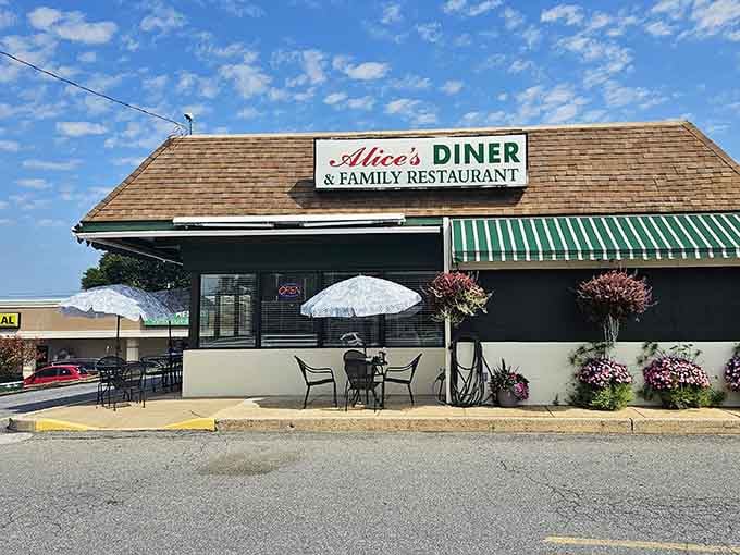 Classic striped awning and outdoor seating signal serious breakfast business happening behind those doors every single morning.