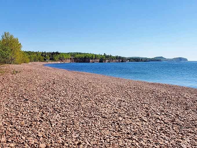 Pink pebbles stretch endlessly along Superior's shore, creating Minnesota's most photogenic beach that nobody talks about.