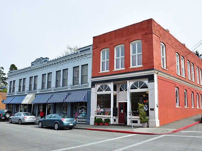 Mismatched storefronts create a delightful architectural hodgepodge that somehow works better than any planned development ever could dream of achieving.