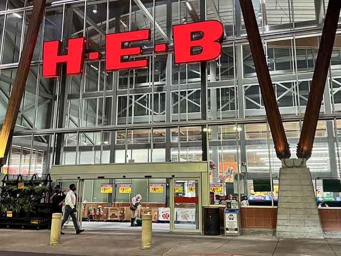 That iconic red H-E-B sign towers over the entrance like a beacon of hope for hungry shoppers everywhere.