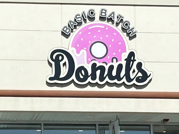 That cheerful pink donut logo at Basic Batch Donuts promises exactly what's waiting inside: pure happiness.