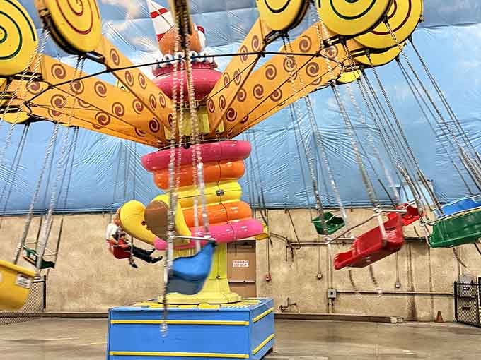 Nothing says "we've conquered the elements" quite like carnival swings twirling under a perpetually sunny artificial sky.