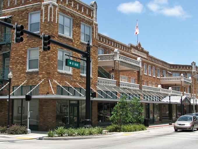 Classic brick buildings and shaded sidewalks create the kind of Main Street America that feels like stepping into a Mayberry episode.