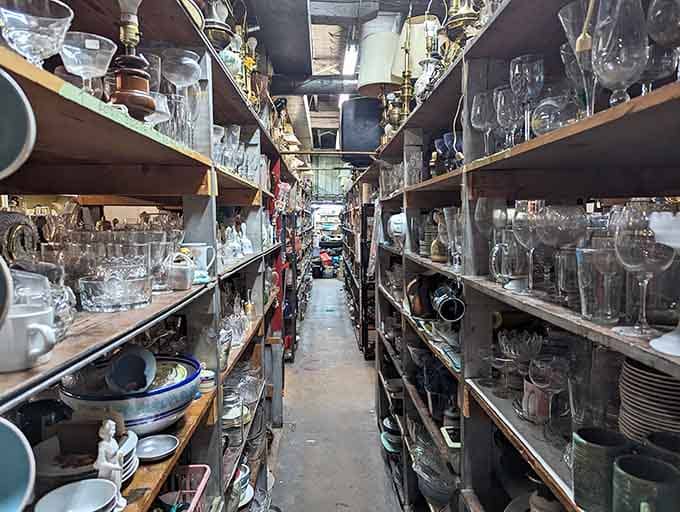 Glassware aisles stretch endlessly like a crystal canyon, holding everything from everyday tumblers to fancy stemware for special occasions.