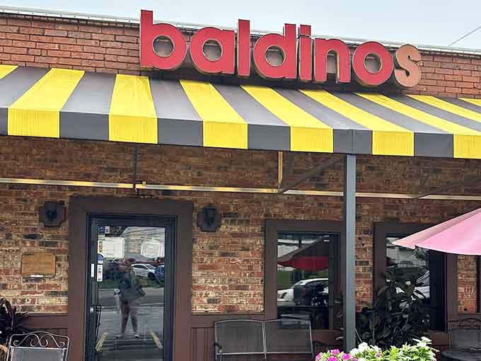 Those cheerful yellow and black striped awnings aren't just decoration, they're a beacon of sandwich salvation in Doraville.