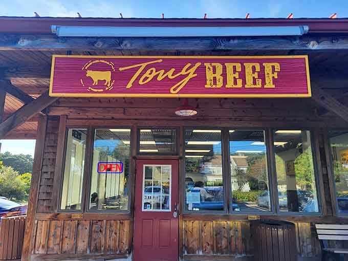 That rustic wooden exterior and glowing neon sign promise serious burger business, like a roadside beacon for the hungry.