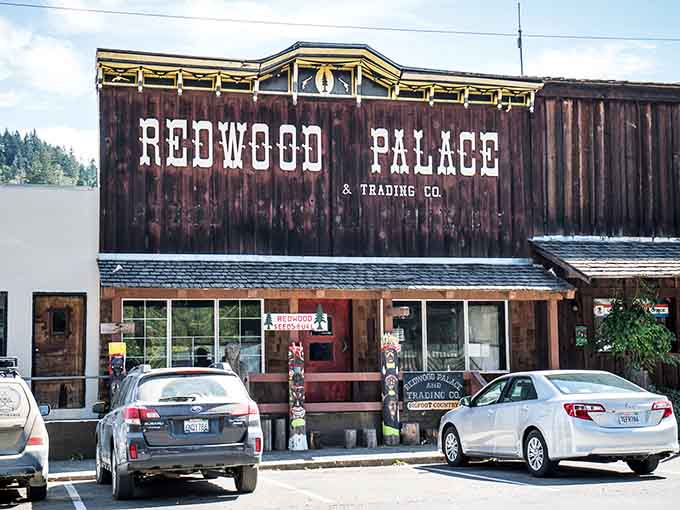 The Redwood Palace stands proud in weathered wood glory, beckoning hungry travelers like a delicious beacon of hope.