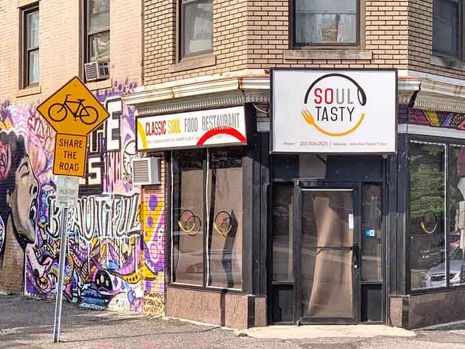 The vibrant exterior mural sets the tone for the colorful flavors waiting inside Soul Tasty Restaurant in Stamford.
