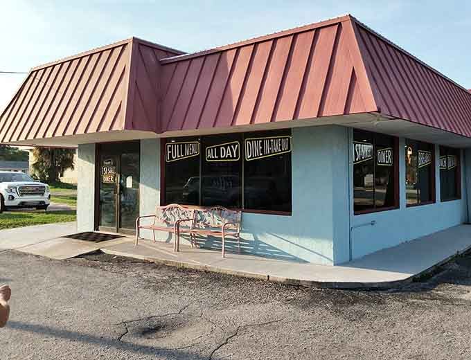 That cheerful blue exterior with the red-striped awning is your beacon to breakfast bliss in Winter Haven.