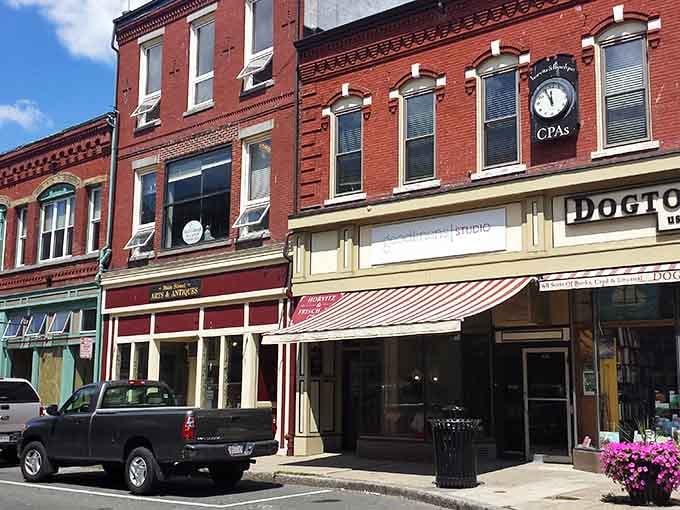 Classic New England storefronts line Main Street, where history meets your credit card in the best possible way.