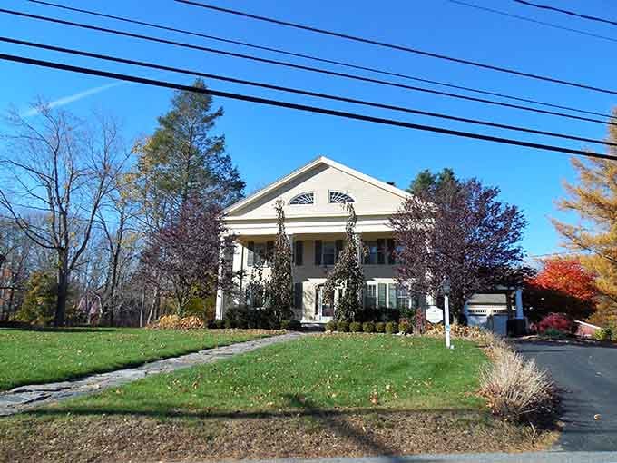 Classic New England architecture meets autumn perfection, where ivy-draped columns frame a scene straight from a Hallmark movie.