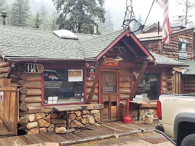 Snow dusting the roofline transforms an already charming log cabin into a postcard that somehow serves burgers and cold beer inside.