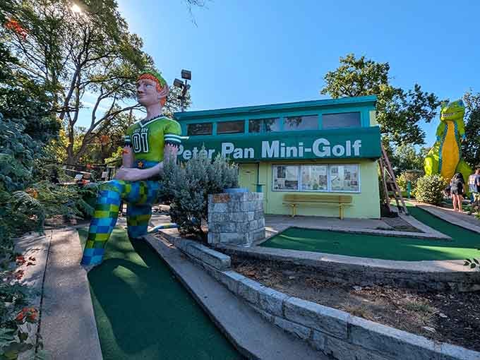 That giant Peter Pan isn't just waving hello, he's basically daring you to stay serious about adulting today.