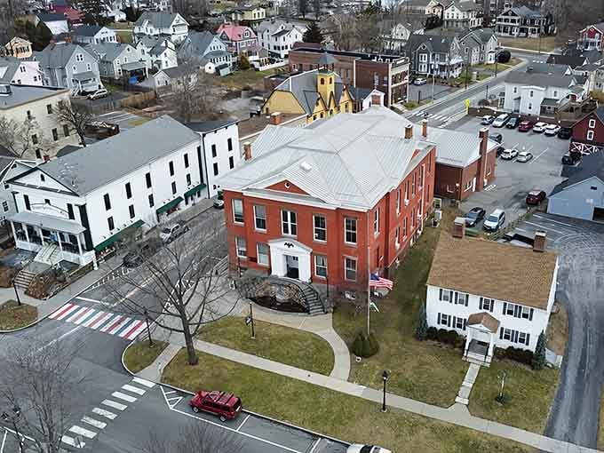 Aerial views reveal New Milford's historic charm, where red brick buildings tell stories spanning generations.