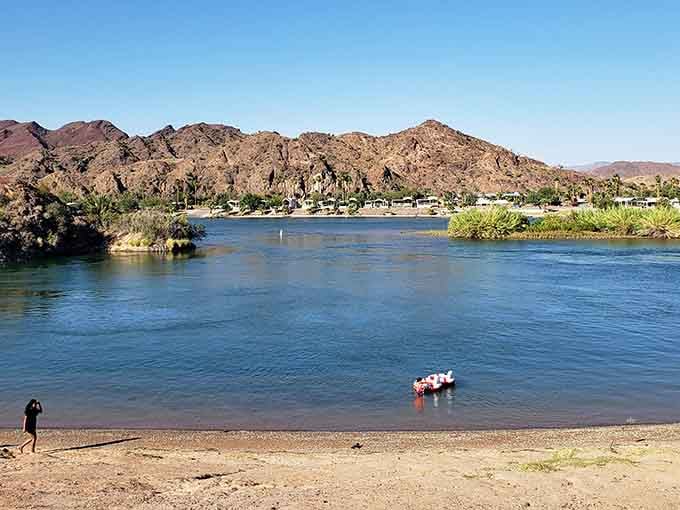 The Colorado River meets desert mountains in a scene that looks like Mother Nature showing off.