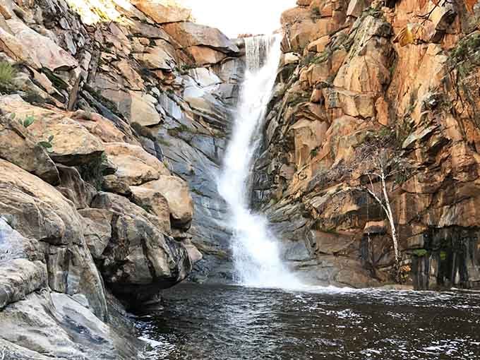 This is what happens when Mother Nature decides to show off—80 feet of pure waterfall perfection cascading into paradise.