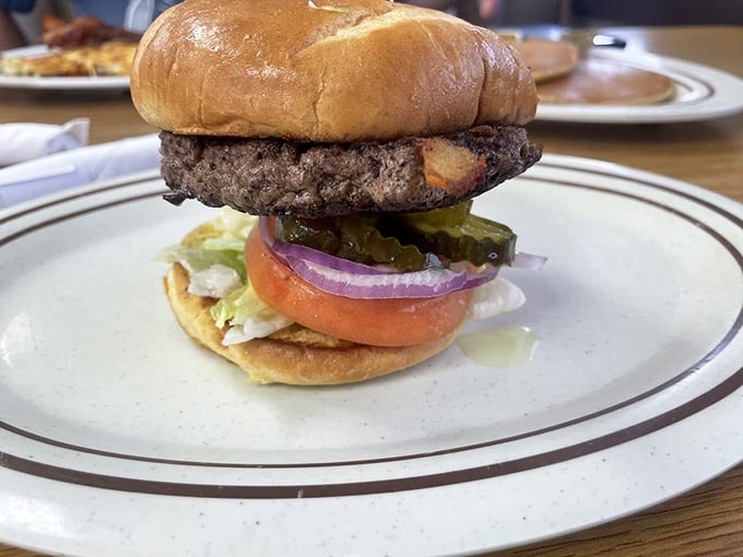 This burger stacked with pickles, onions, and tomatoes looks like it means serious business on a bun.