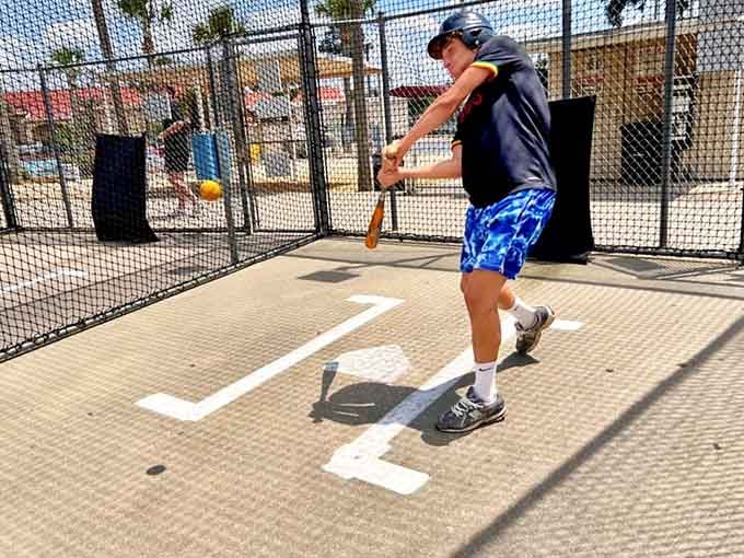 The batting cage: where baseball dreams meet reality, and reality usually involves some enthusiastic swinging and missing.
