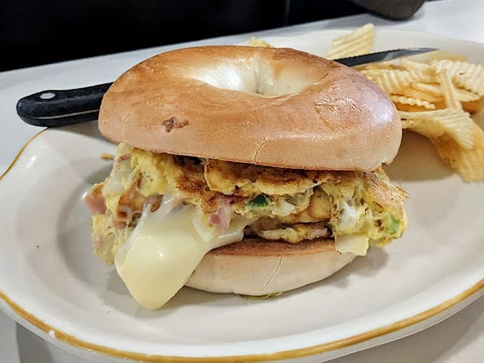 A bagel sandwich stuffed with Western omelet filling proves that breakfast innovation doesn't require fancy ingredients, just creativity.