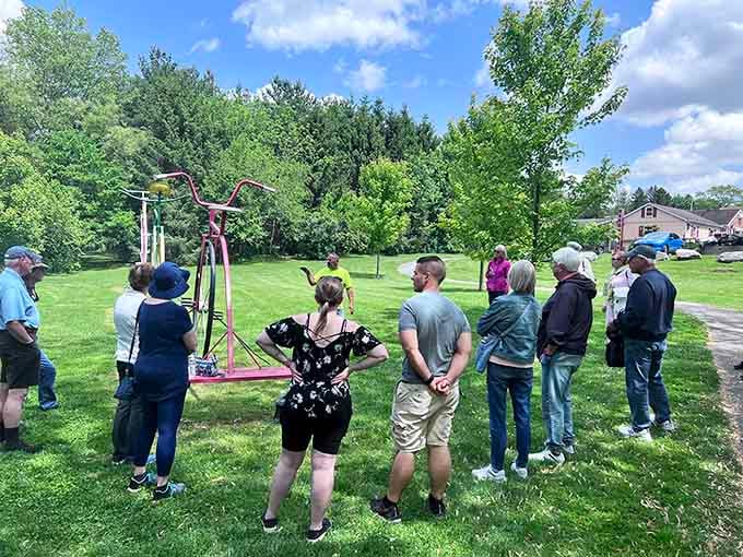 Curious visitors gather around vintage cycling equipment, probably wondering if their grandparents actually rode those contraptions back then.