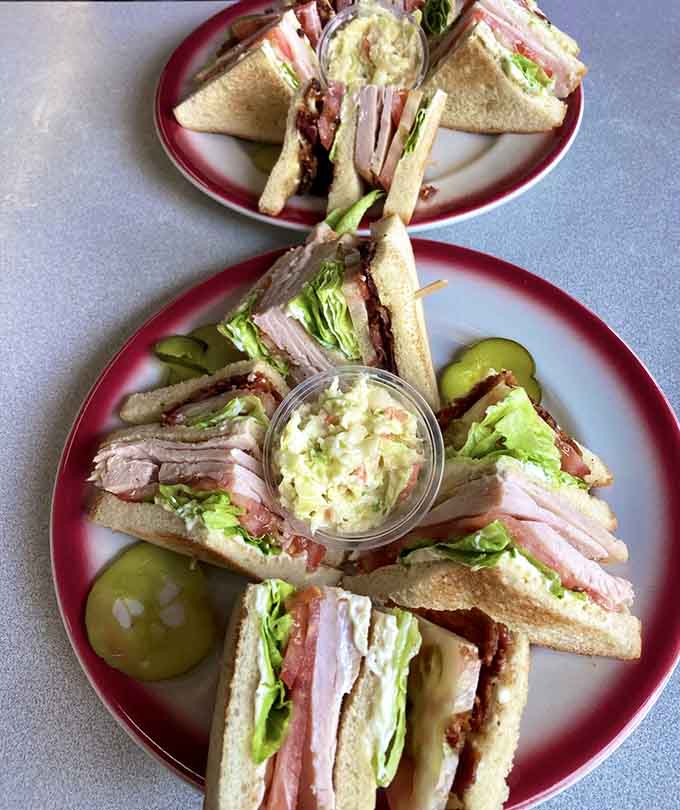 Triple-decker club sandwiches engineered with the precision of a architect and the soul of grandma's kitchen.