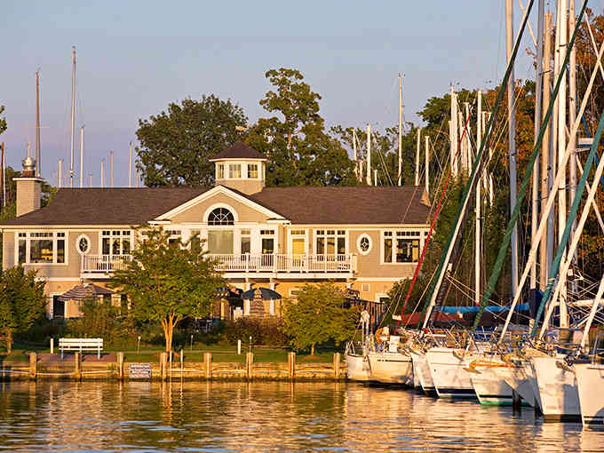 Yacht club elegance bathed in golden hour light, where the boats cost more than most zip codes.