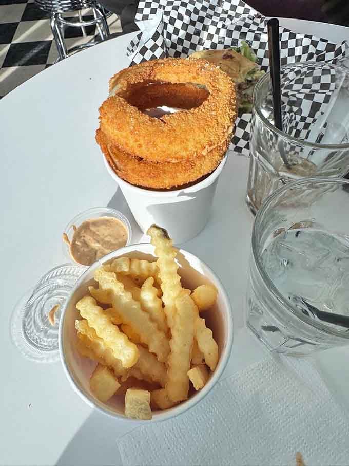 Onion rings towering over fries like the delicious skyscraper of fried goodness they were meant to be.