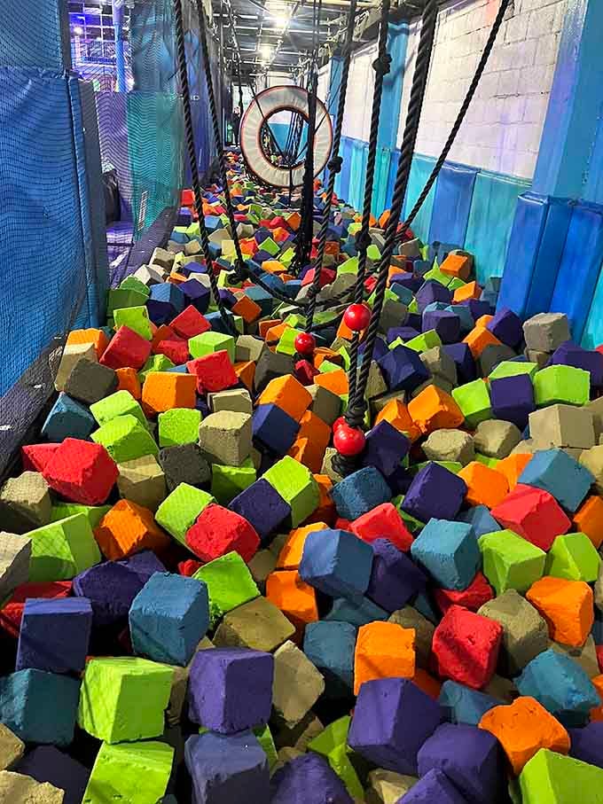 The foam pit catches failed acrobatic attempts with the gentle embrace of a thousand soft cubes.