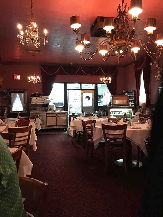 Multiple chandeliers illuminate a dining room that's witnessed more celebrations than a champagne bottle at midnight.