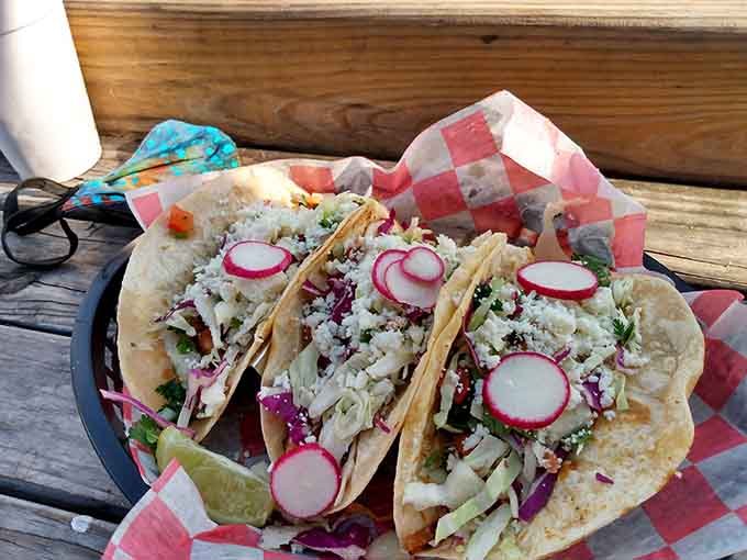 Fresh tacos topped with radishes and cabbage slaw, because even floating bars understand the importance of proper taco construction.