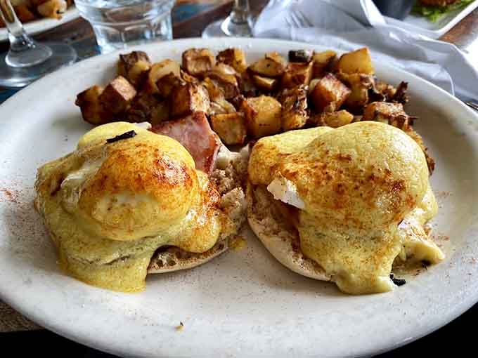 Eggs Benedict done right: when hollandaise sauce and perfectly poached eggs create breakfast poetry on a plate.