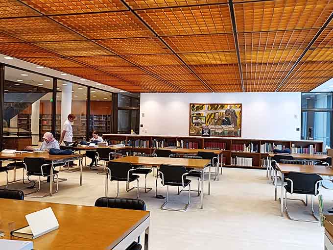 A reading room where serious scholars do serious work, probably feeling very scholarly while doing it all seriously.