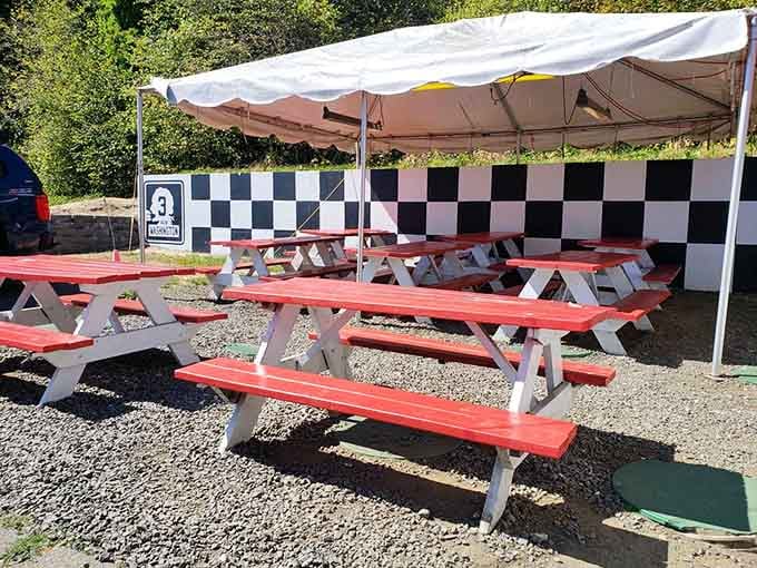 Checkered racing flags and red picnic tables create the perfect outdoor dining room for your burger feast ahead.