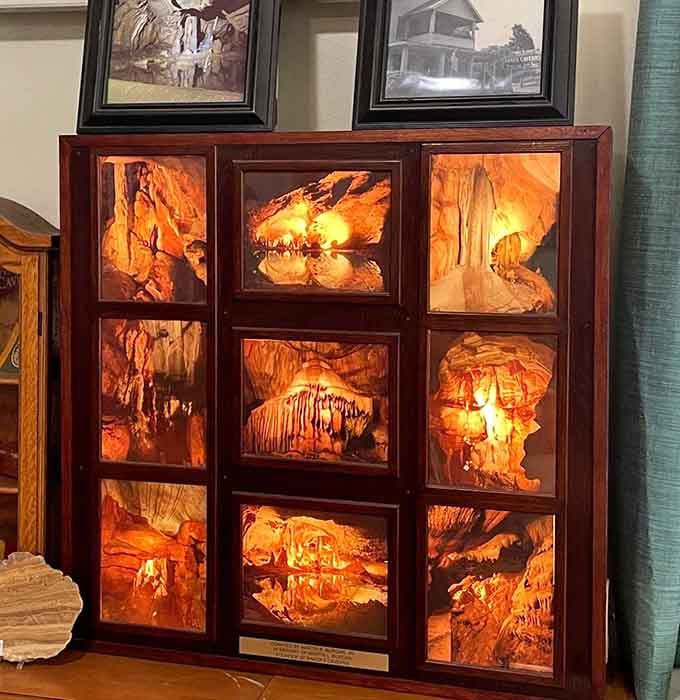 Backlit formations glow like amber jewels in a wooden frame, capturing the cavern's greatest hits in one stunning photographic display.